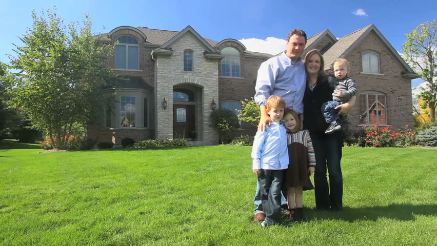 A Happy Family Plays In The Front Yard Of Their Luxury Home Stock ...