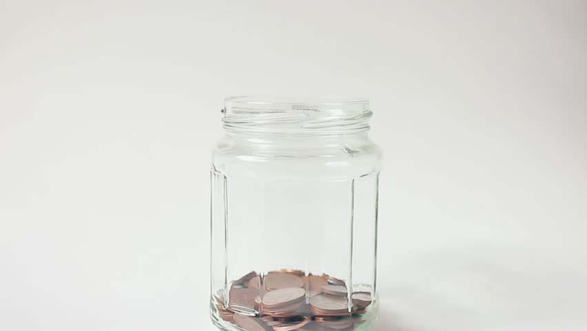 Coins Fall Into Clear Jar In Slow Motion. A Clear Jar Fills Up With ...