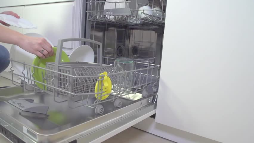 Dishwasher. Happy Young Woman In The Kitchen Doing Housework ...