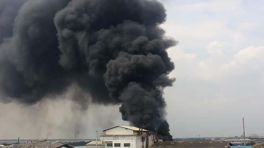 Massive Black Smoke From A Building Far Away Wide Shot. Industrial ...