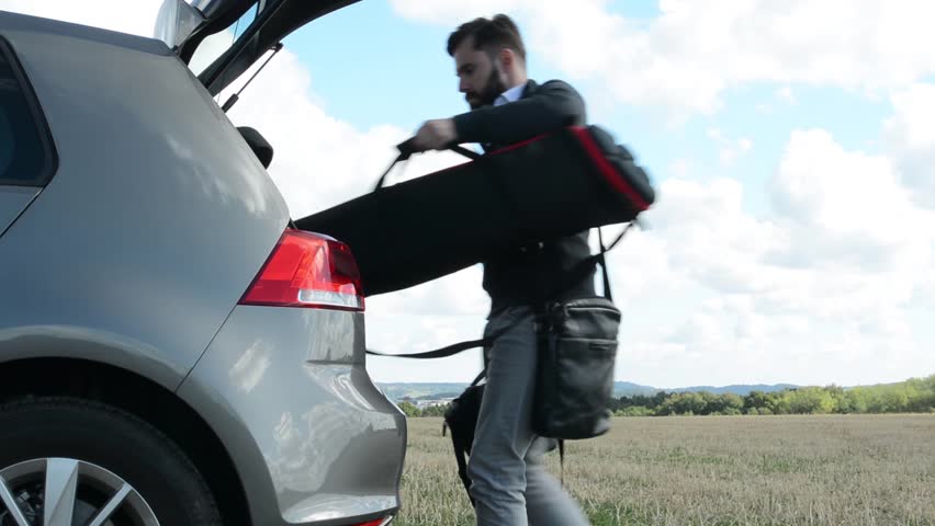 Man Opens The Car Trunk And Putting In A Bag In For A Journey. Car ...