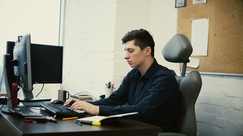 Stock video of man working in office in front | 14410114 | Shutterstock
