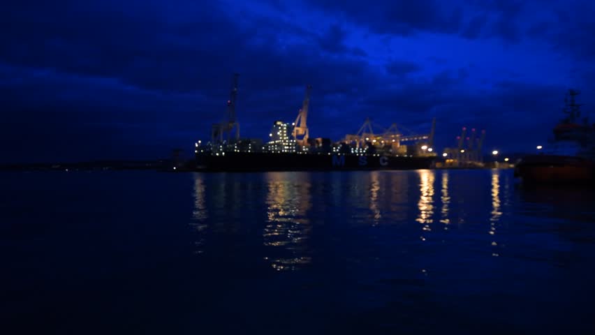 Boat Is Sailing Along The River Or Sea Bay At Night, Lights Of A City ...