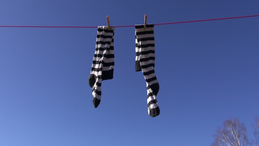 Sliding Dolly Shot Of White Socks Hanging On A Clothes Line And Blowing ...