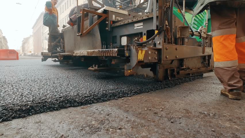 Asphalt Paver Applying Asphalt On The Highway. An Equipment Used To ...