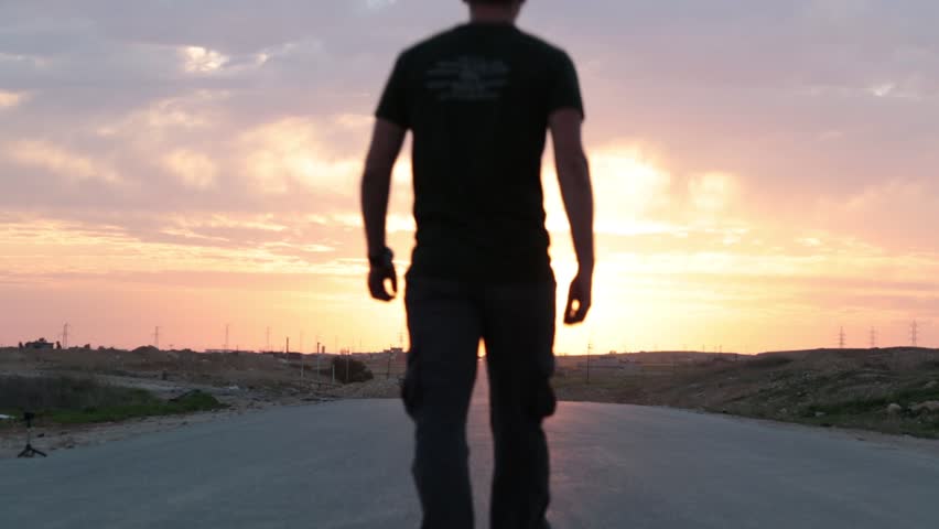 Man Walking Down A Road And Into The Sunset Stock Footage Video ...