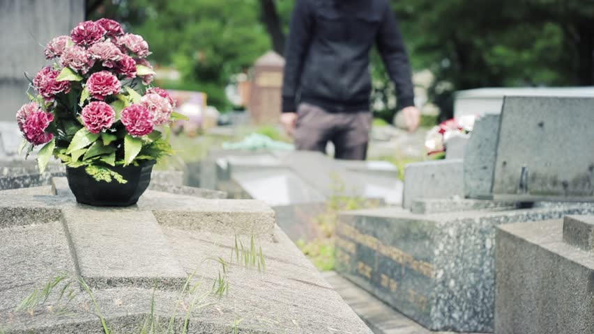 Man Crying In Tomb Of A Cemetery And Then Leaves. Desperate Young Man ...