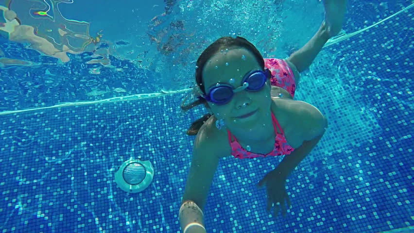 Underwater View, Young Girl Swimming In Pool With Her Brother And ...