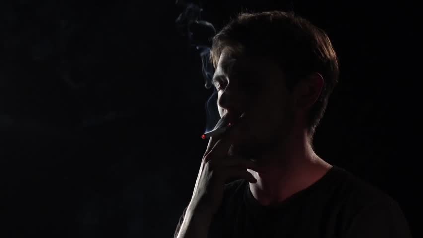Stock video of man smokes a cigarette turned sideways. | 18347044 ...