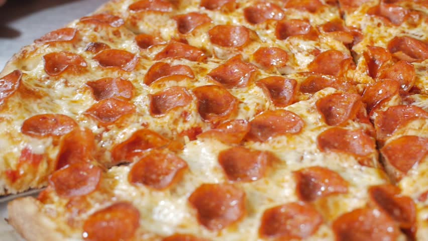 Slow Motion Close-up Of Drooping Slice Of Pepperoni Pizza Cooked In ...