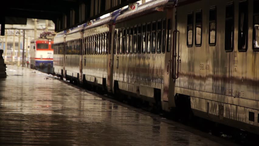 Wet Railway Station Platform With Train Carriages Standing In ...