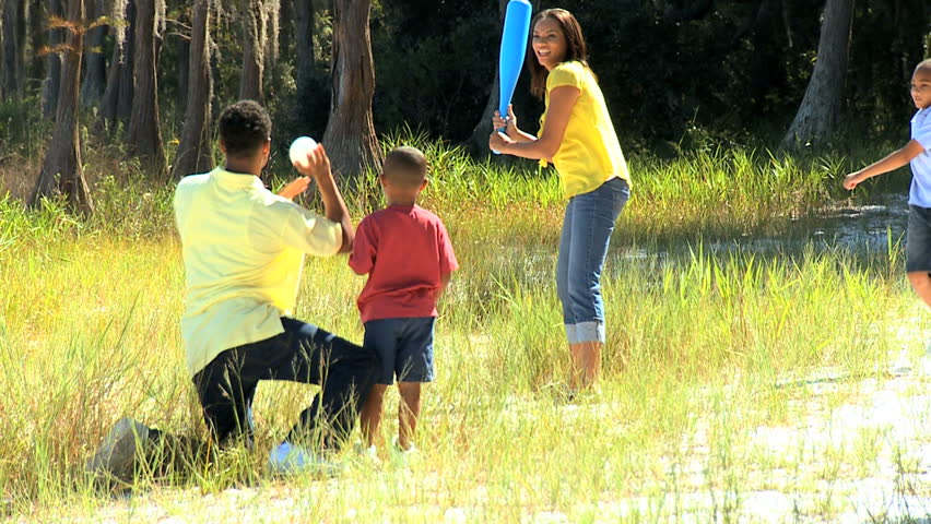 Healthy Young Ethnic Family Having Fun Playing Baseball Together In The ...