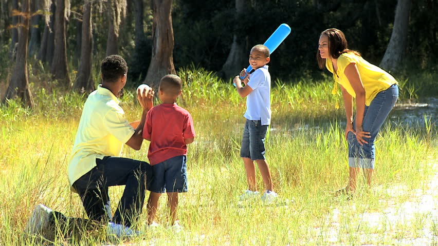 Healthy Young Ethnic Family Having Fun Playing Baseball Together In The ...