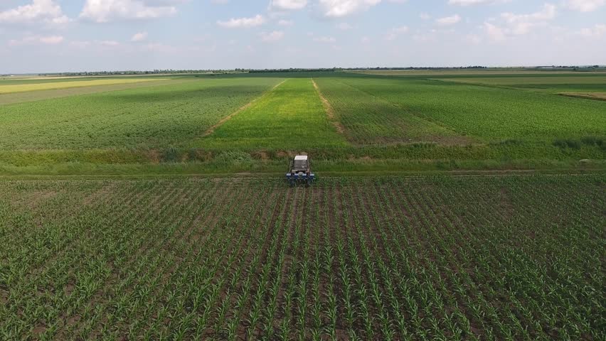 Aerial Side Front Of Tractor Farmer Flattening Land Using Roller ...