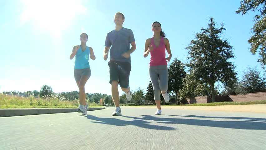 Stock Video Clip of Three fit young people keeping fit jogging ...