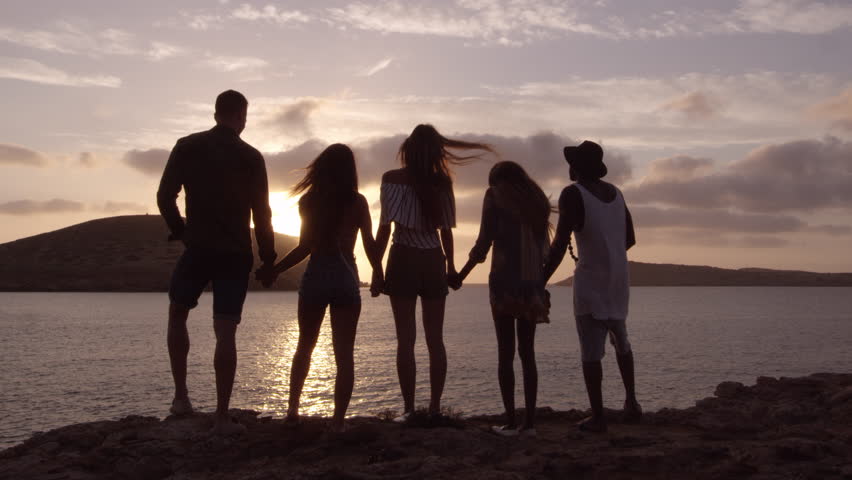 Stock Video Clip of Friends Standing On Cliff Watching Sunset Shot ...