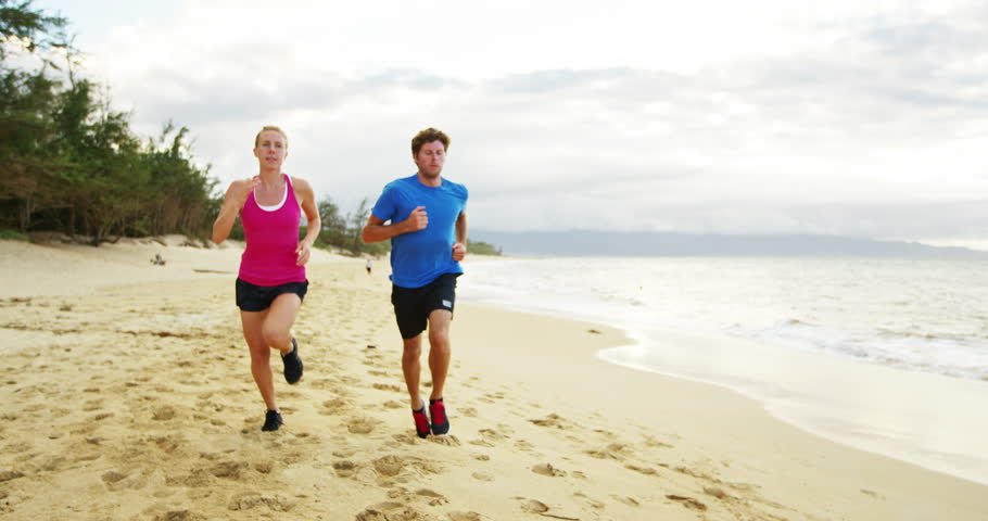 People Running On Beach Training And Jogging. Runners Couple Working ...