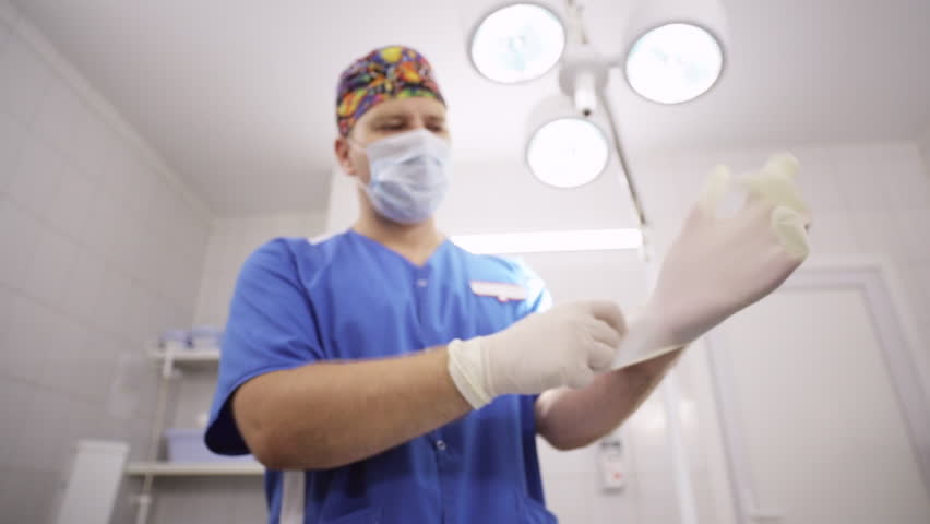 Slider Shot of Doctor Putting Stock Footage Video (100% Royalty-free ...