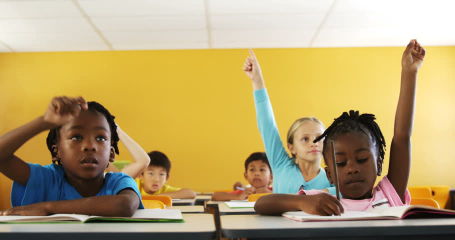 Smiling School Kids Raising Hands In Classroom At School 4k Stock ...