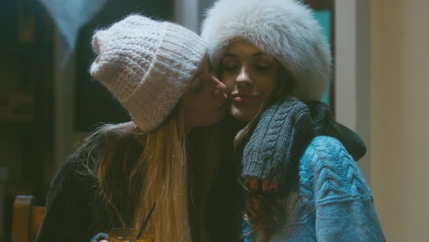 Beautiful Young Woman Giving Teenage Girl Friend Kiss On Cheek Hugging ...