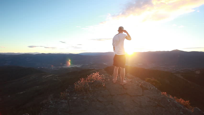 Young Caucasian Man Staring Into The Sunset While Seing Mountains And ...