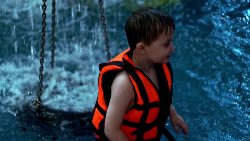 Stock Video Clip of Boy playing in water swimming pool. Children ...
