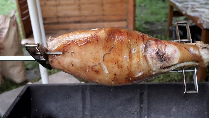 Roast Pork Leg At Grill, Large Chunk Meat Cooked On Spit, Pig Roasted ...