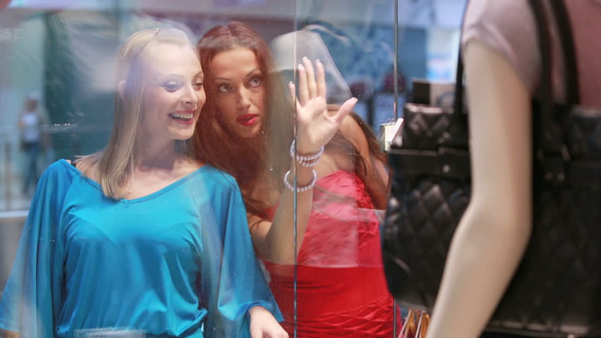 Excited Shopping Girl Rummaging Through Clothes In The Sales Section ...