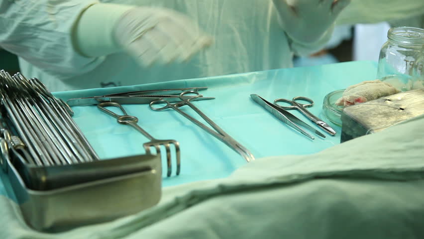Surgeon In Blue Gloves Preparing Instruments Before Surgery. Wipe ...
