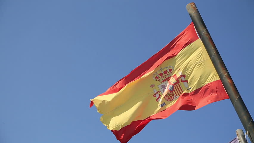 Spanish Flag Flying On A Flagpole Against The Blue Sky Stock Footage ...