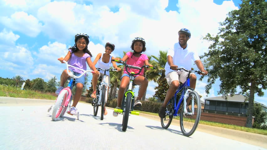Healthy Young African American Family Outdoors Together Riding Their ...