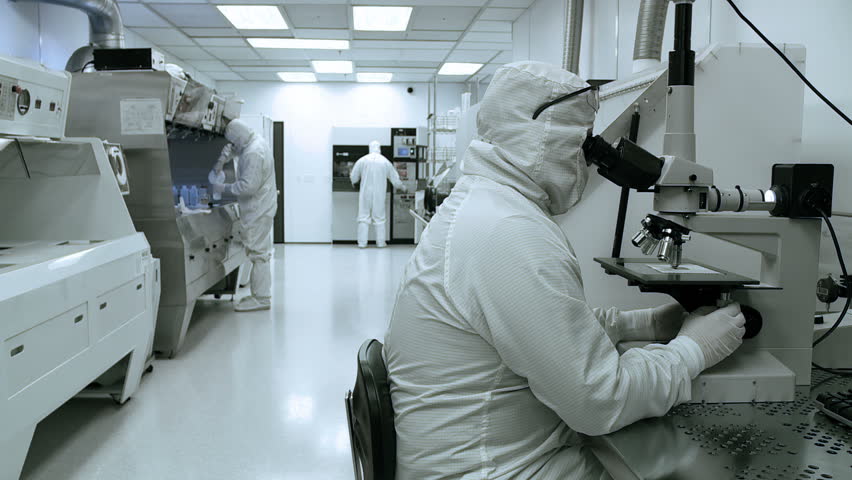Clean Room Wide. Scientists / Technicians Working On Silicon Chip ...
