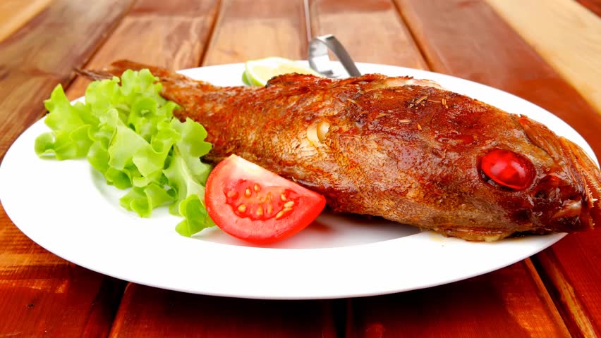 Stock Video Clip of savory on plate : roast golden fish | Shutterstock