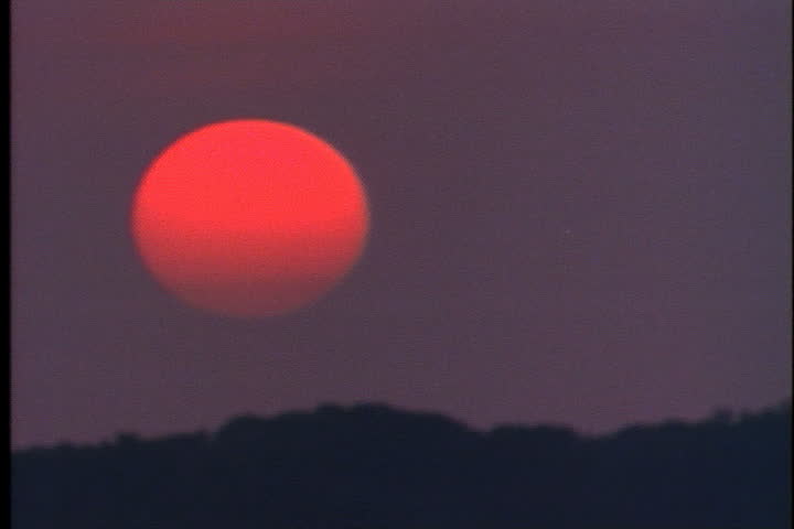 Big, Red Fireball Sun Sinking Into Purple Sky At Sunset At Oyster Bay ...