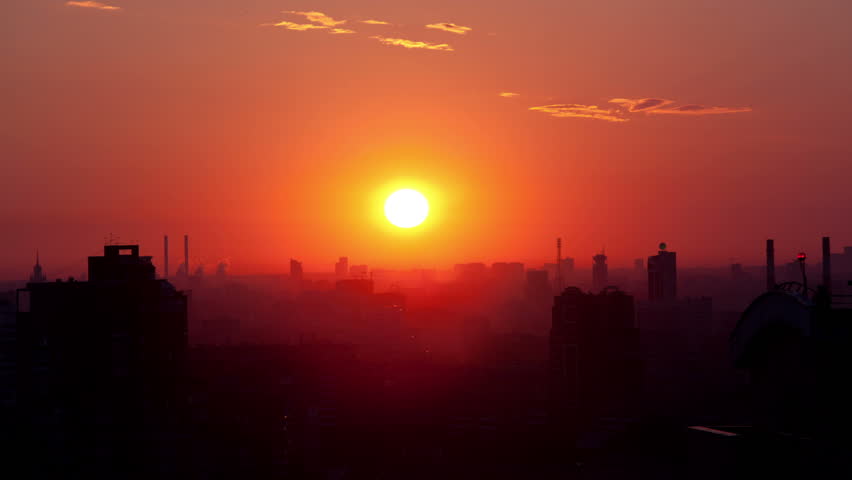A Time-Lapse Of The Sun Setting Over The City And Disappearing Behind ...