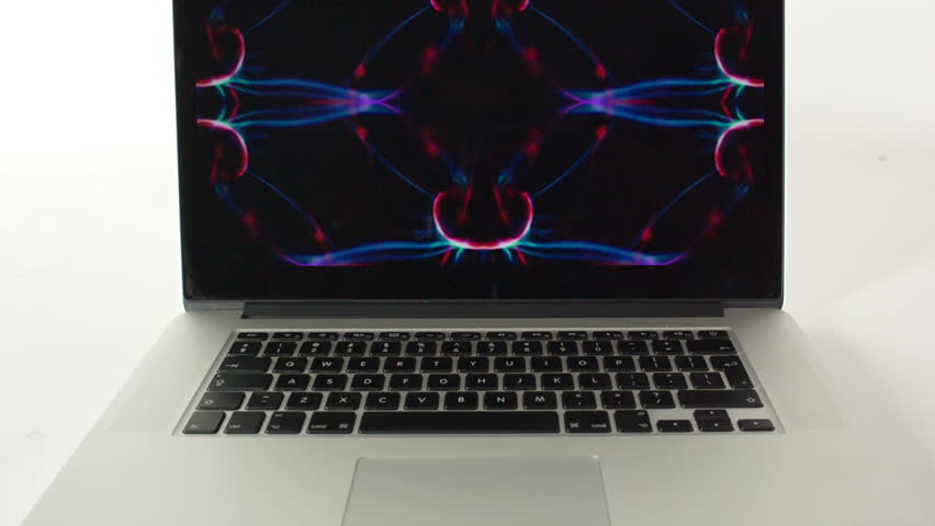 A Laptop Computer With An Abstract Screensaver Playing. The Screen ...