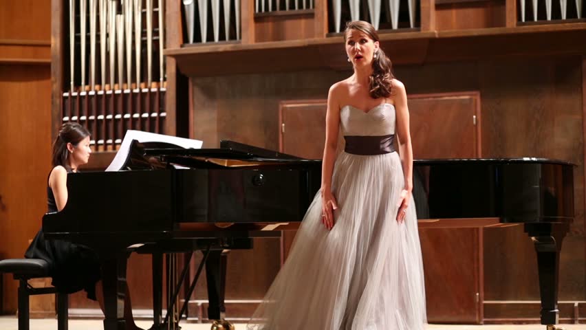 Graceful Woman Pianist And Opera Singer Finishes The Performance At ...