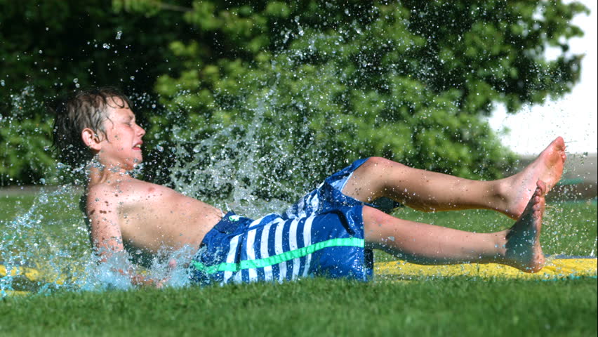 Young Boy On Water Slide In Slow Motion, Shot With A Phantom Camera At ...