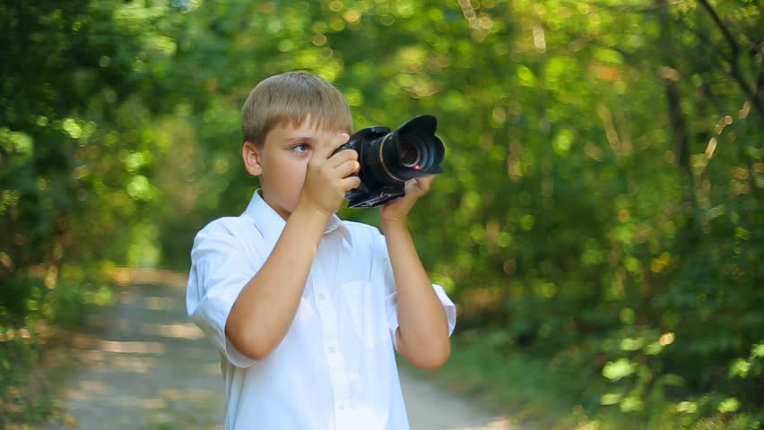 Boy Takes Pictures And Views Photos On DSLR Camera. Childhood Dreams ...