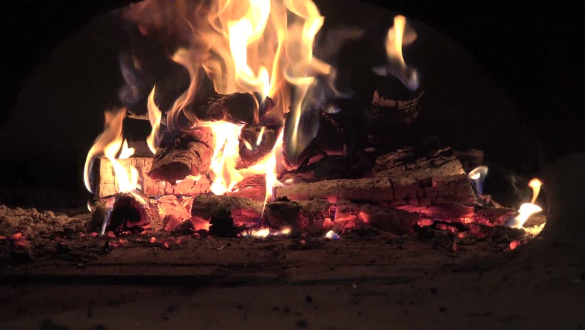 Man Stoking Fire With Stick - Wood Burning Fire With Flames In ...